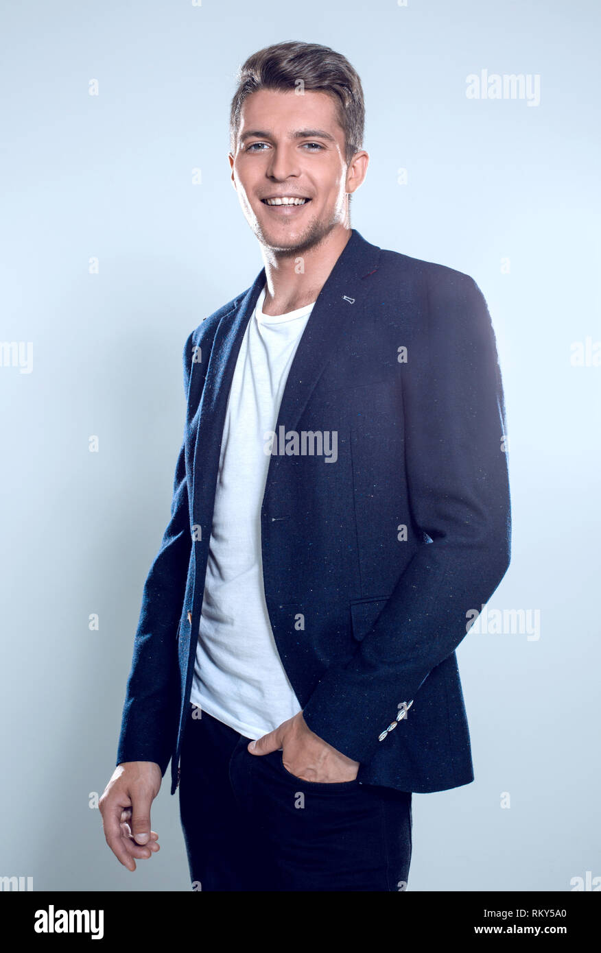 Studio portrait of a serious young man in suit Stock Photo - Alamy