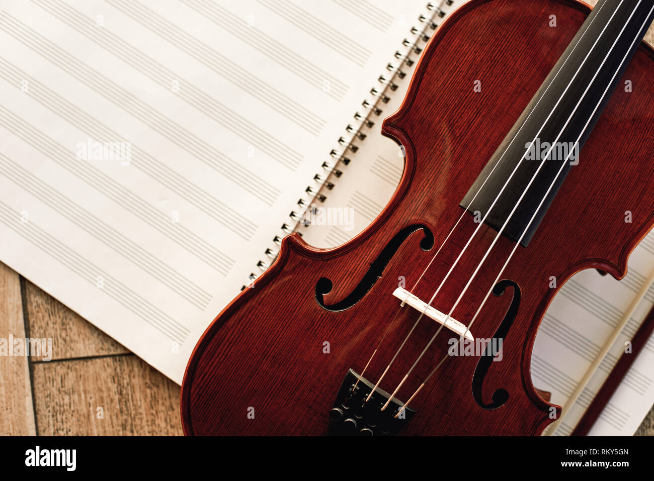 Writing Violin Music. Close up view of beautiful brown violin lying on ...