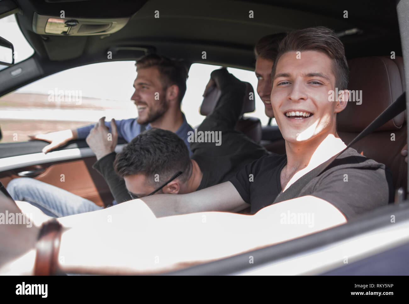 a group of boys rides and looks directly at the car Stock Photo - Alamy