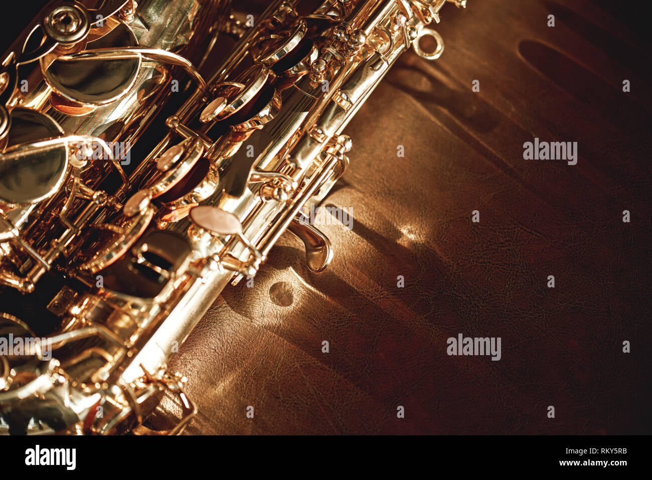 Close up and detailed view of a shiny keys of a golden saxophone lying ...