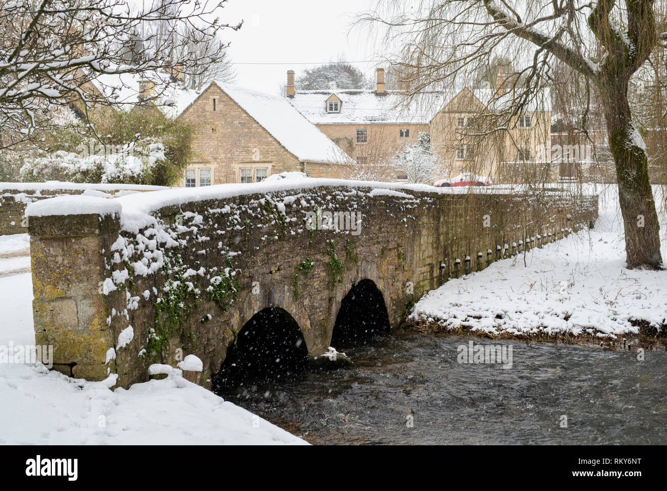 River coln and stone bridge in the cotswold village of Ablington in the ...