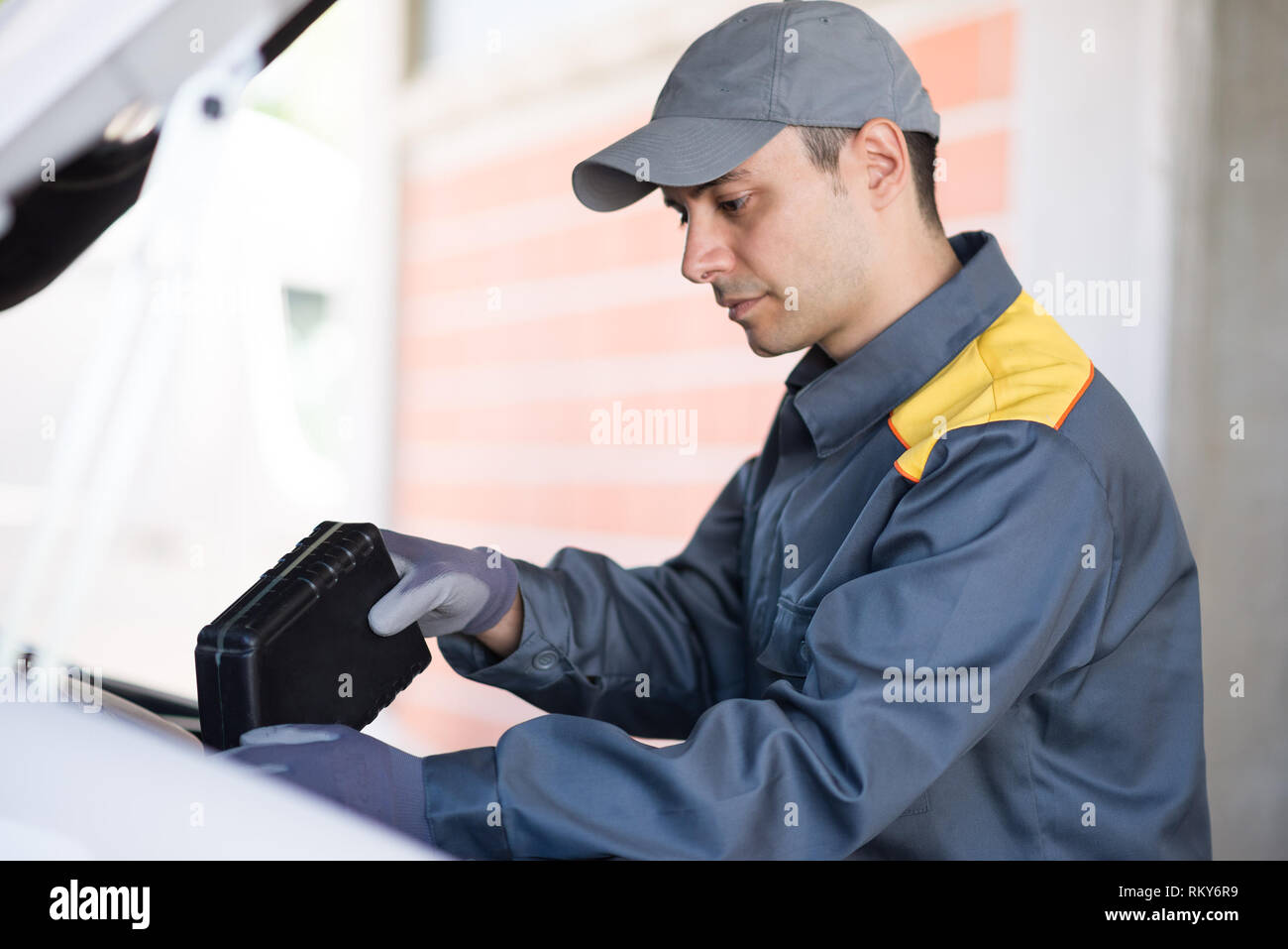 Mechanic putting oil in a van engine Stock Photo - Alamy