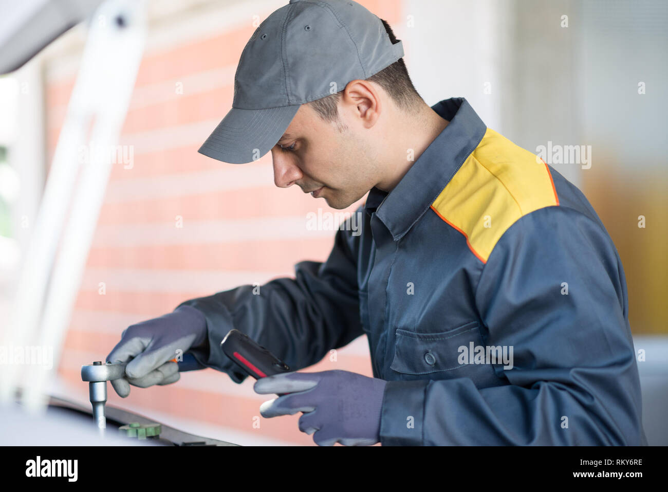 Mechainc fixing a van engine Stock Photo - Alamy
