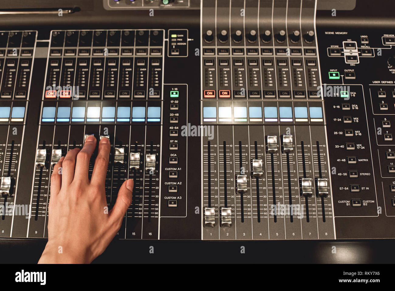 Professional sound control. Close-up view of male hand mixing sounds on ...