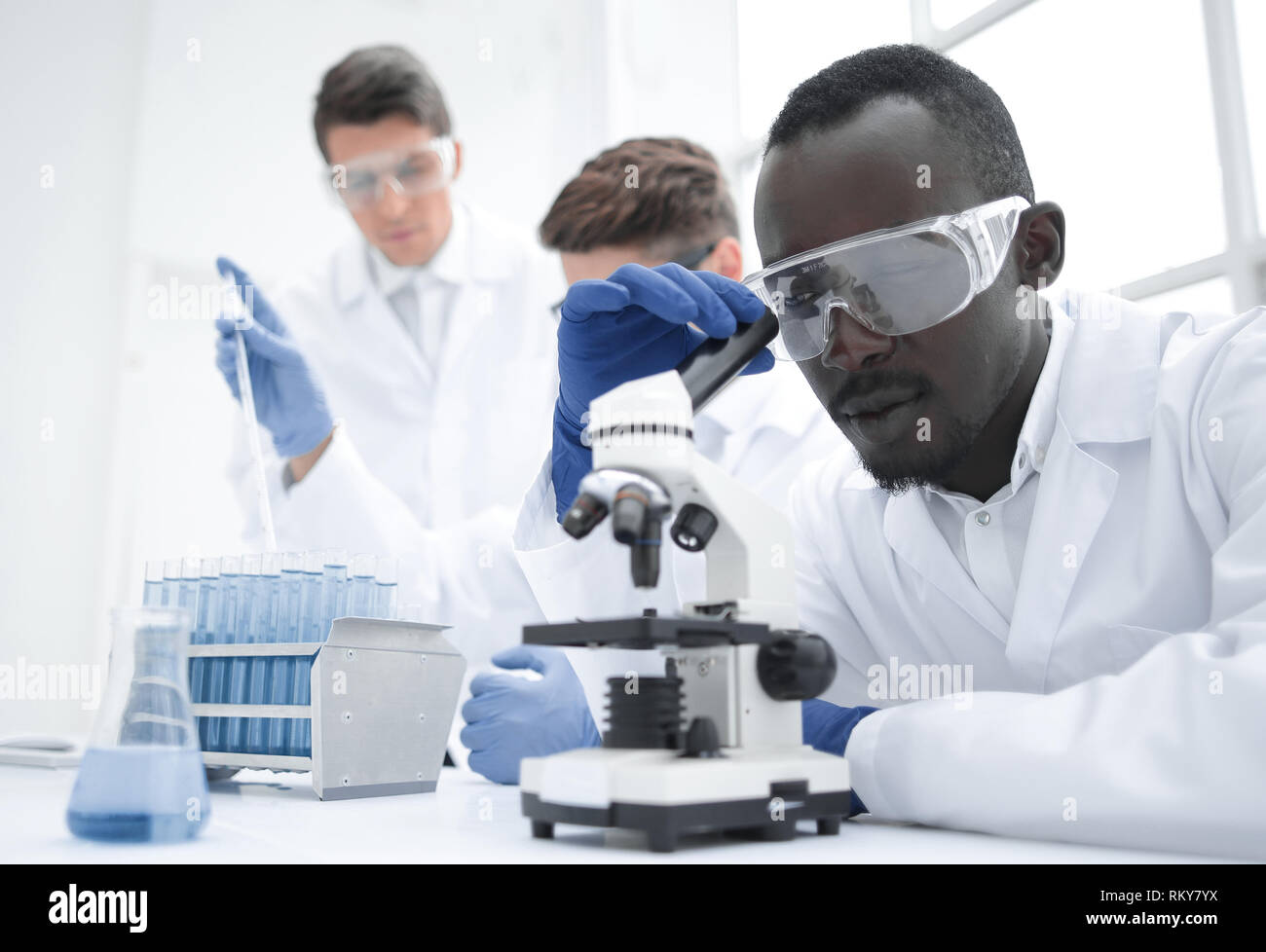 modern scientist looking through a microscope Stock Photo - Alamy