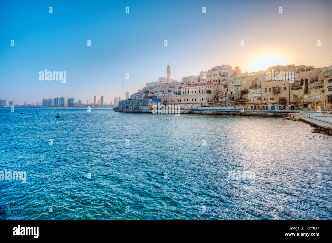 Sun rising over waterfront town, Israel Stock Photo - Alamy