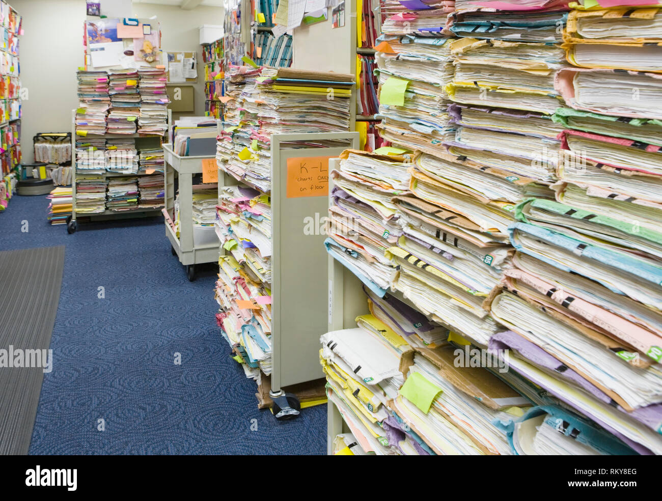 Stacks of papers and folders in library Stock Photo - Alamy