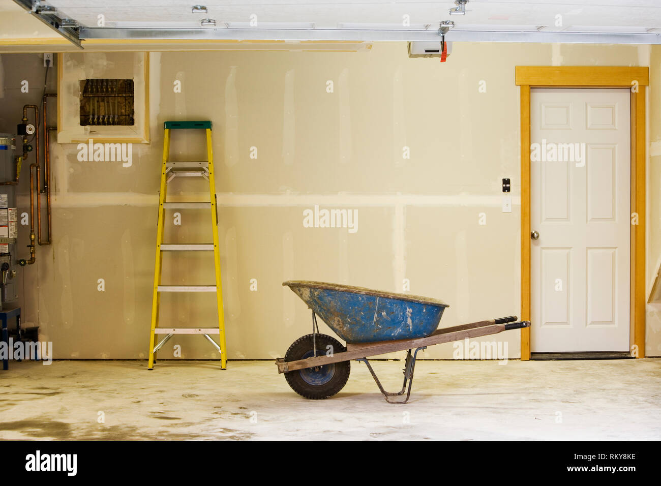 Blue Wheelbarrow in Garage Stock Photo - Alamy