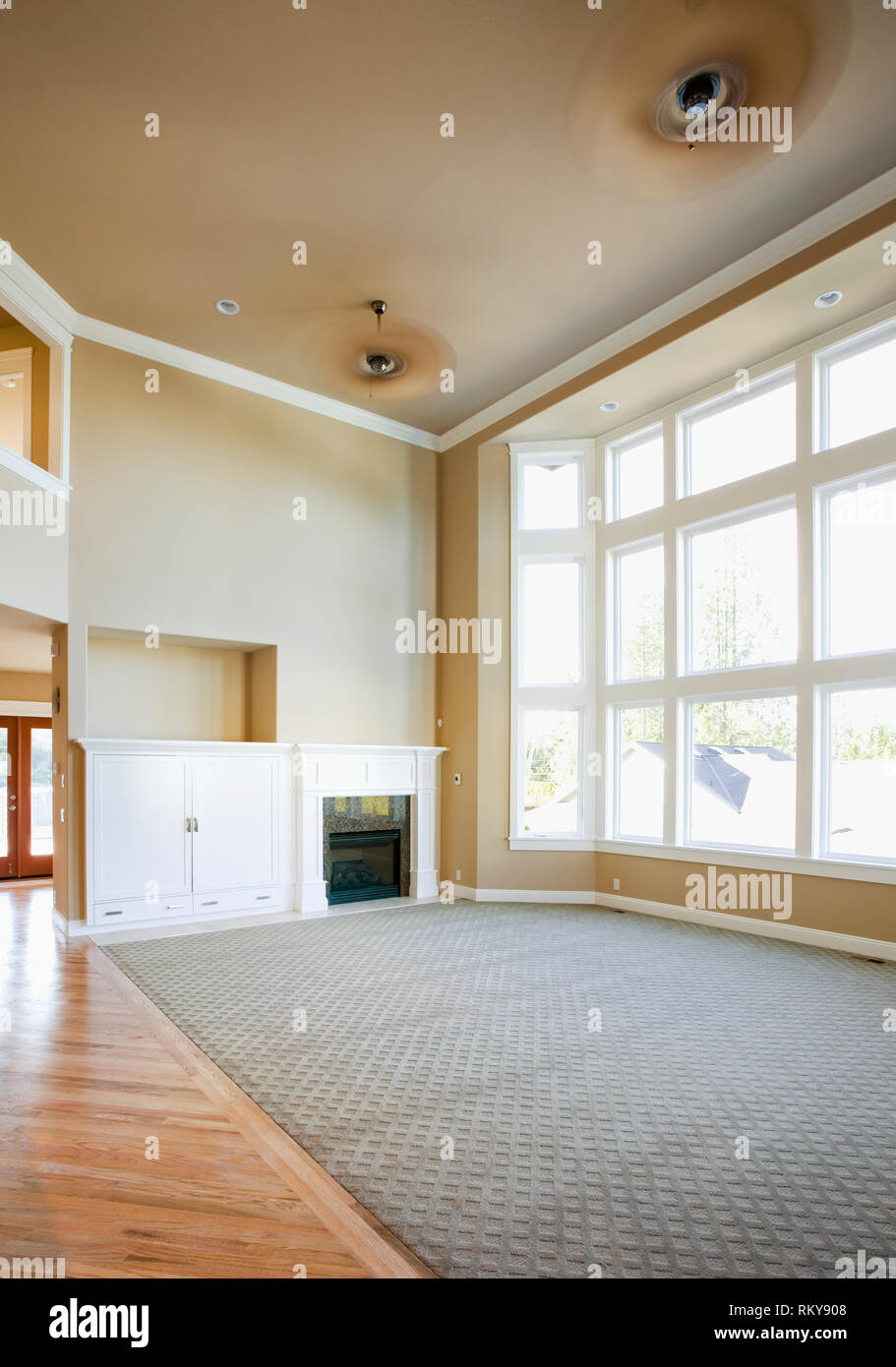 Empty living room with tall windows Stock Photo - Alamy