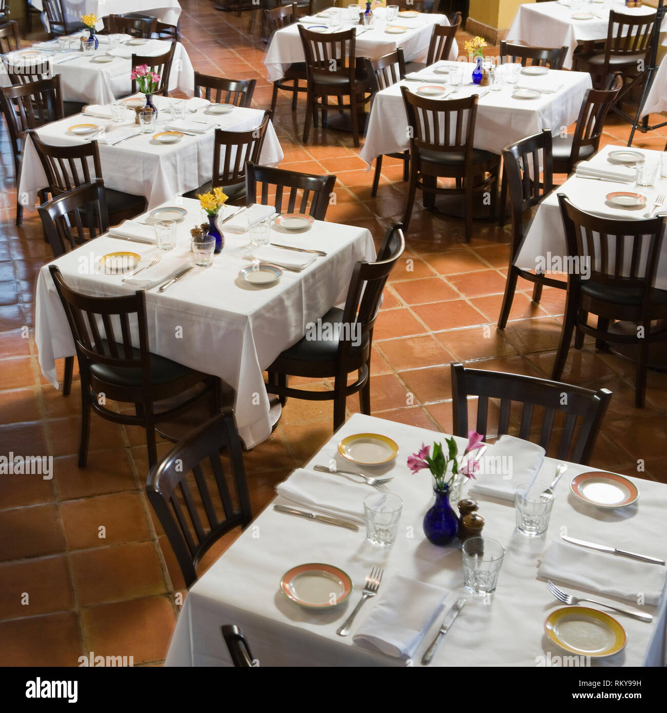 Tables and chairs in empty restaurant Stock Photo - Alamy