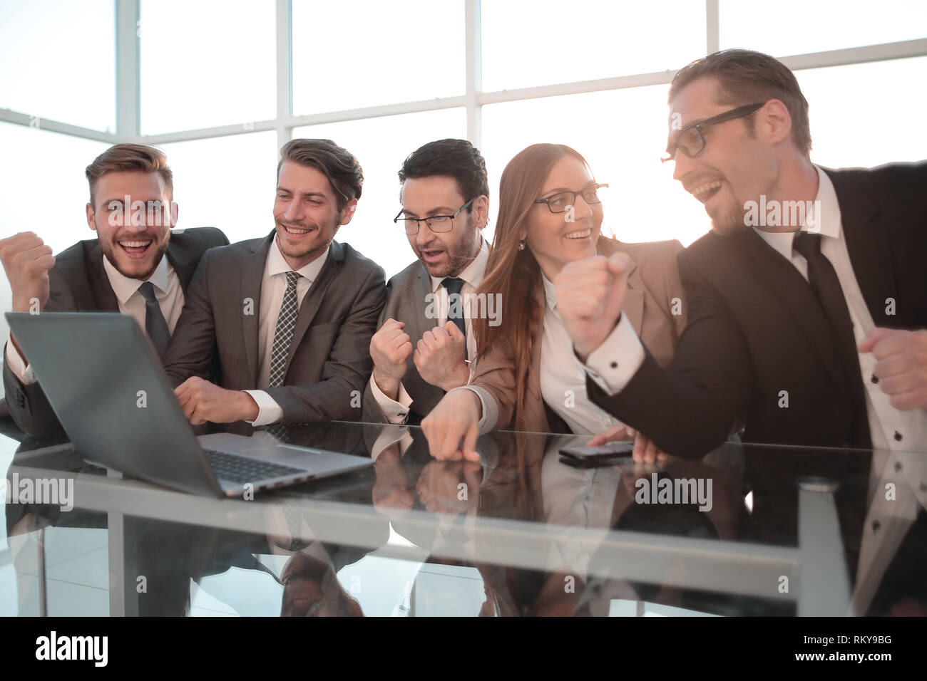 happy colleagues at the desk, hands up Stock Photo - Alamy