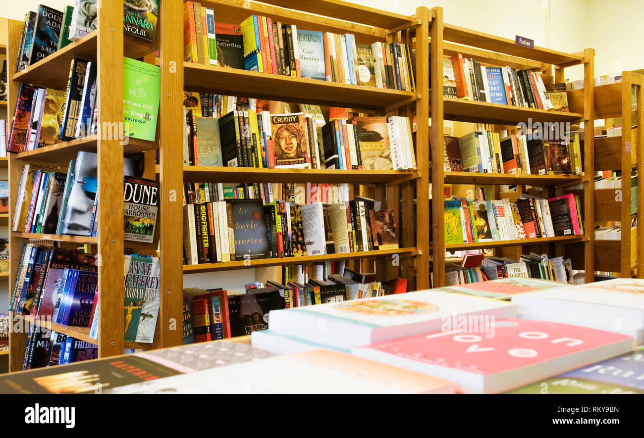 Books on shelves in bookstore Stock Photo - Alamy