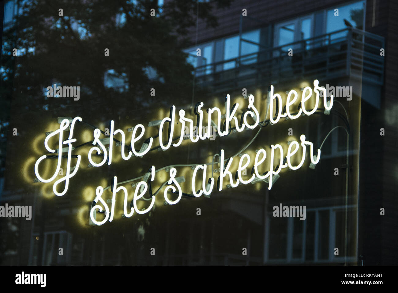 Neon sign through a window Stock Photo - Alamy