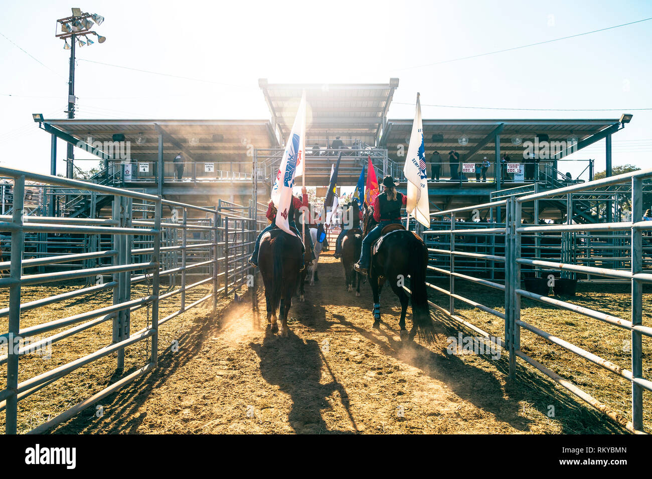 Horseback flag bearers entering arena to begin rodeo Stock Photo - Alamy