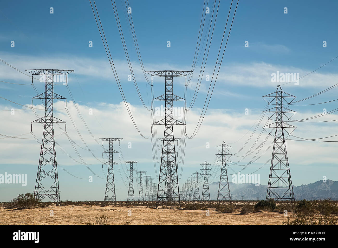 Symmetrical powerline towers in the Yuha Desert of Southern California ...