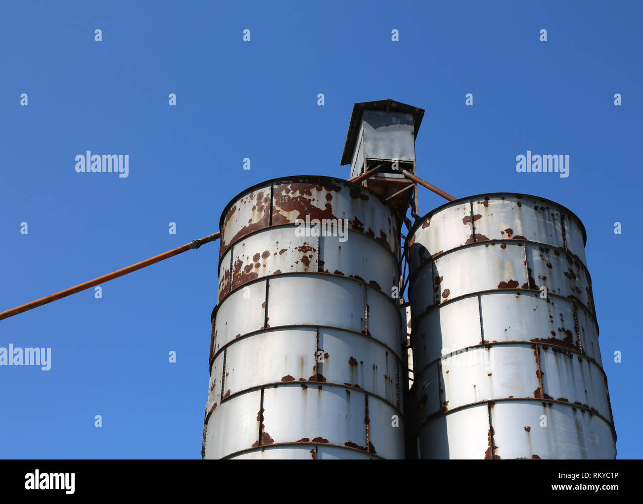 two old rusty silos of the ancient abandoned factory Stock Photo - Alamy