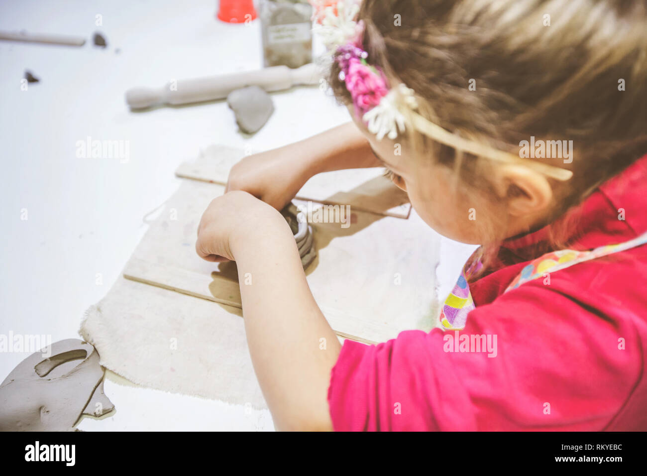 Child pottery workshop, little girl working with clay, creative ...