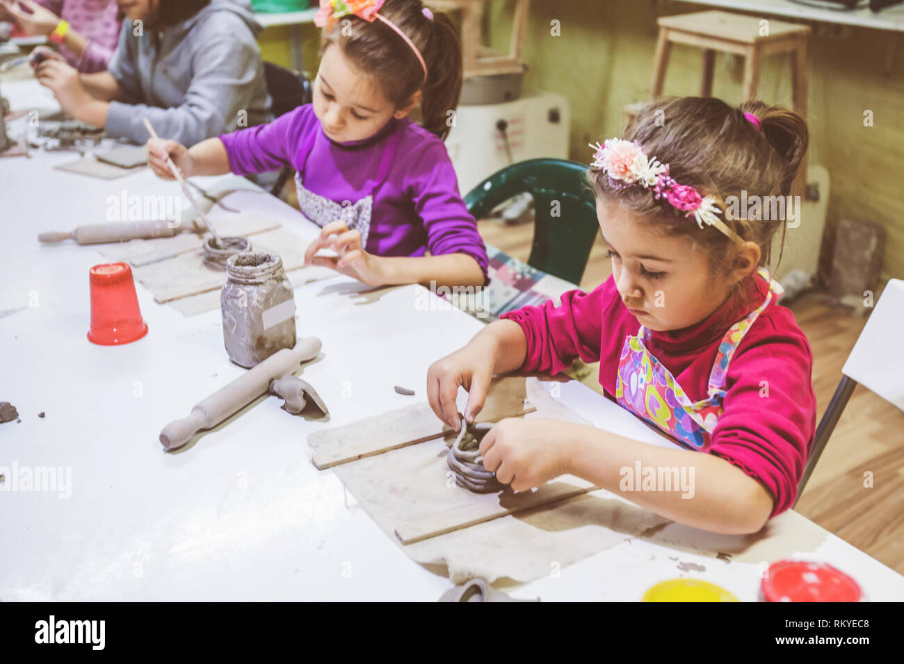 Child pottery workshop, little girl working with clay, creative ...