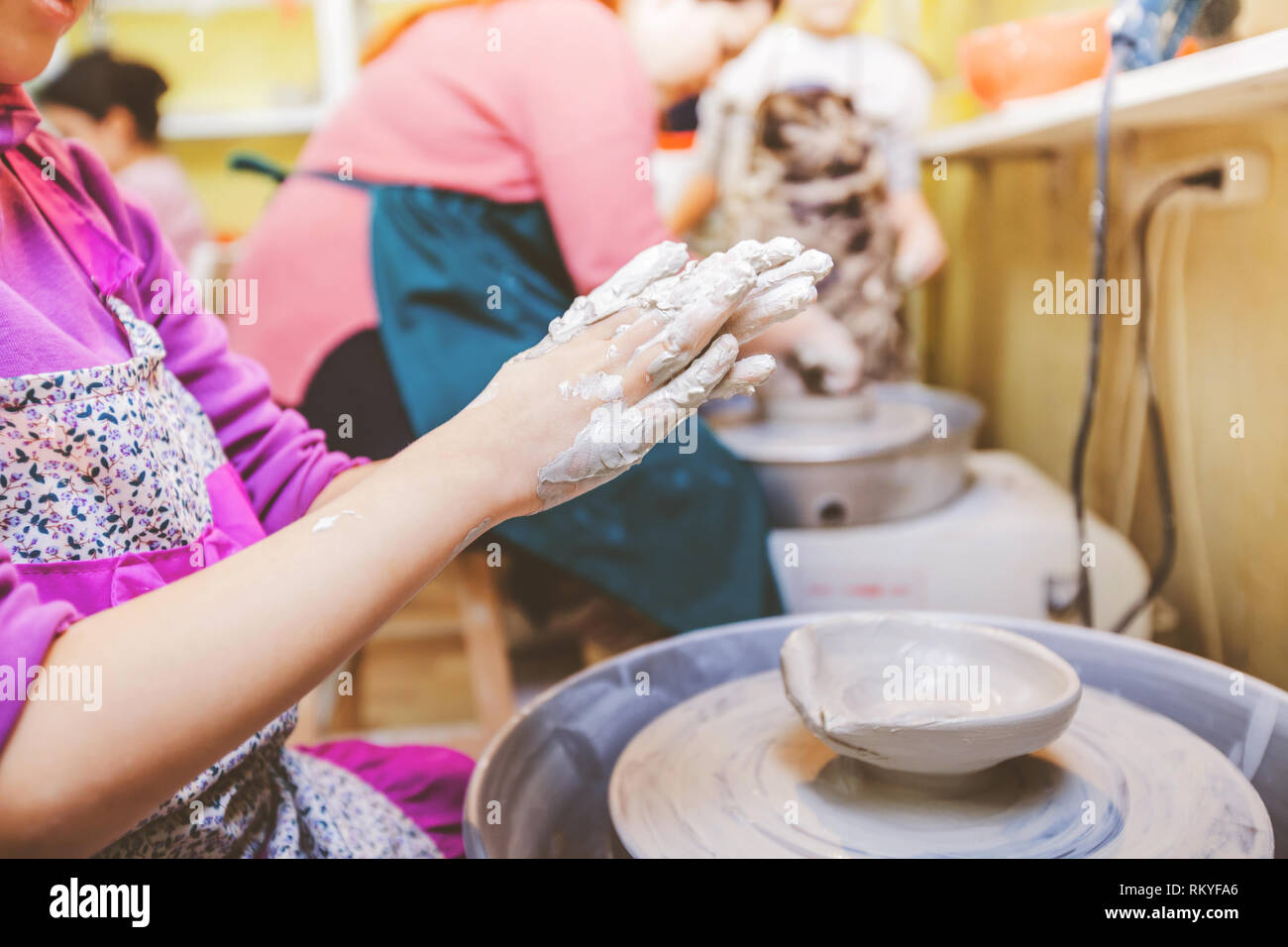 Child hands shaping clay on pottery wheel at workshop Stock Photo - Alamy