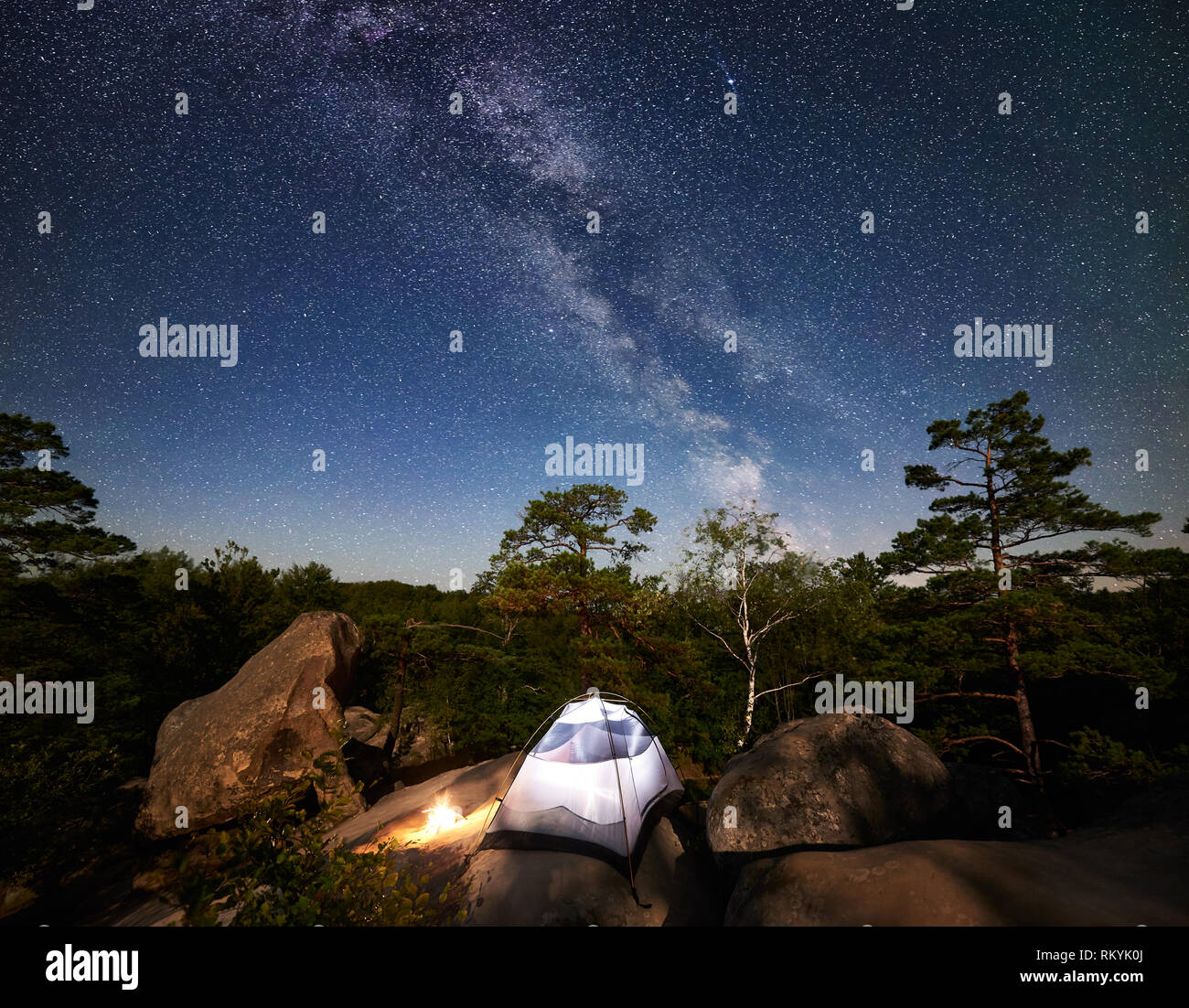 Camping at summer night on rocky mountain. Illuminated tourist tent and ...
