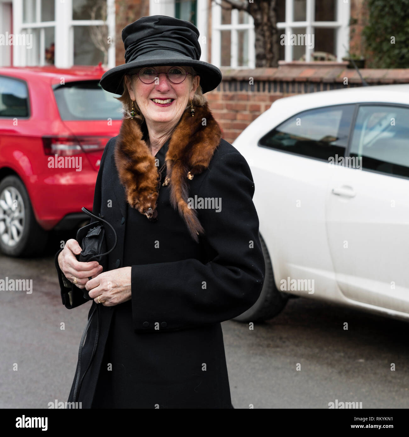 A smart lady in old-fashioned coat and hat with a fox fur stole at a ...