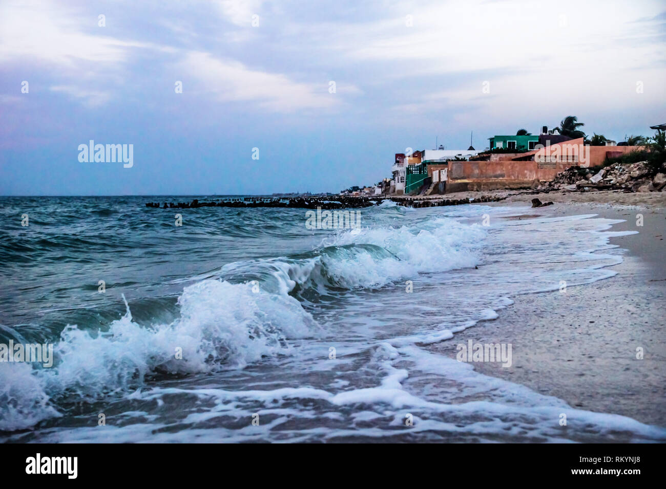 Sunset along the coast with beach and houses of Chelem, Mexico Stock ...