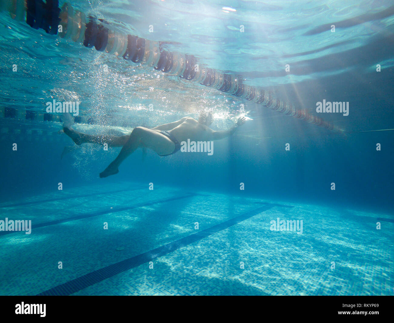 people swimming in pool view from the underwater. sporty lifestyle ...