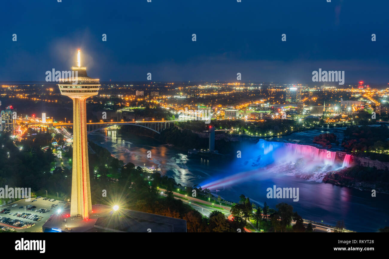 Night aerial view of the Skylon Tower and the beautiful Niagara Falls ...