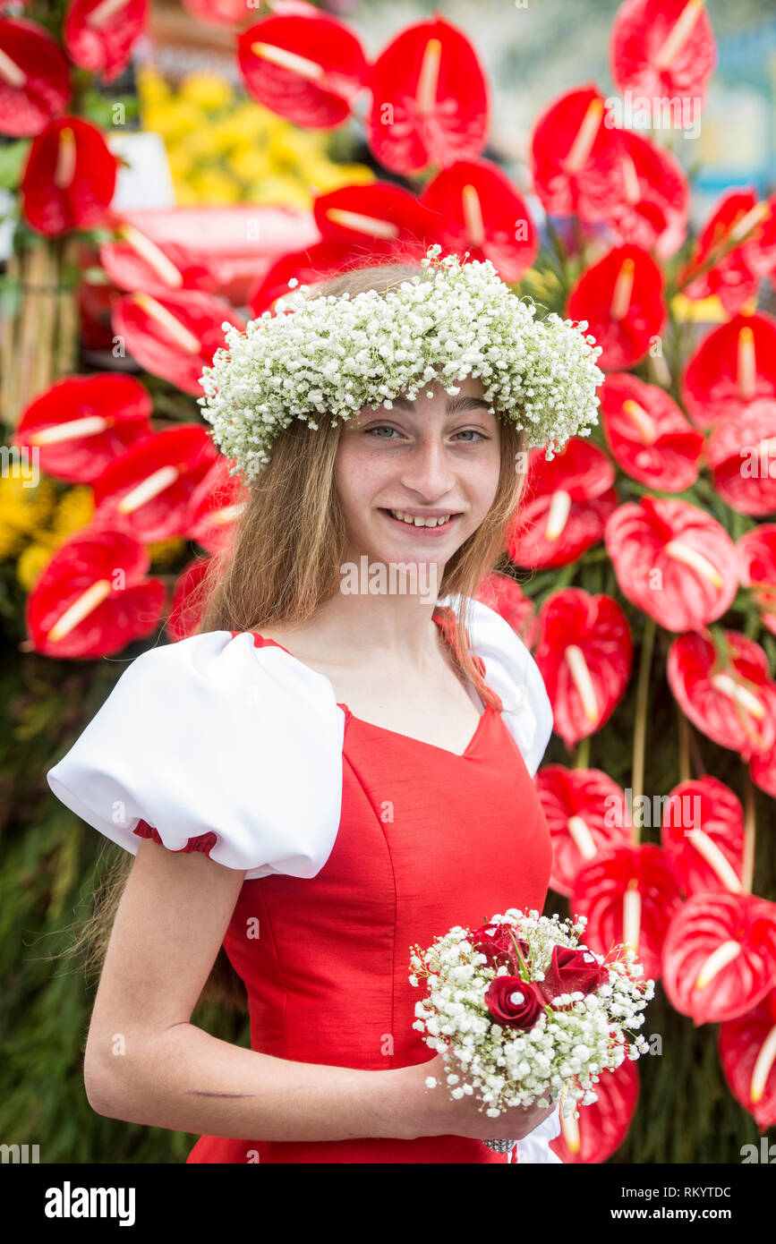 women dressed in colorful clothes at the Festa da Flor or Spring Flower ...