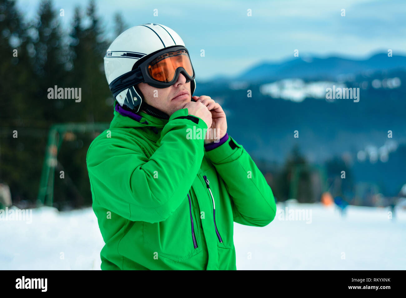 A mountain range reflected in the ski mask Portrait of man at the ski ...