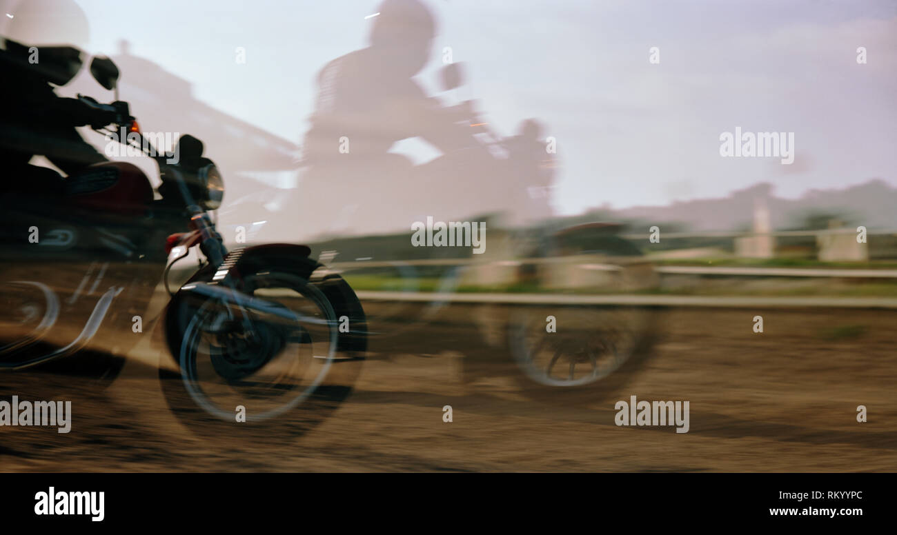 Man riding a motorcycle at speed Stock Photo - Alamy