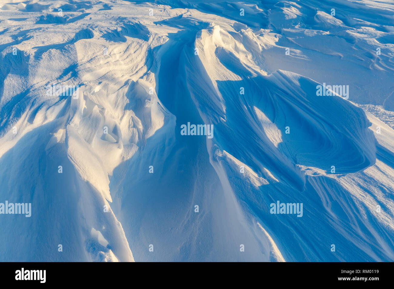 Sastrugi snow with shadows and sun Stock Photo - Alamy