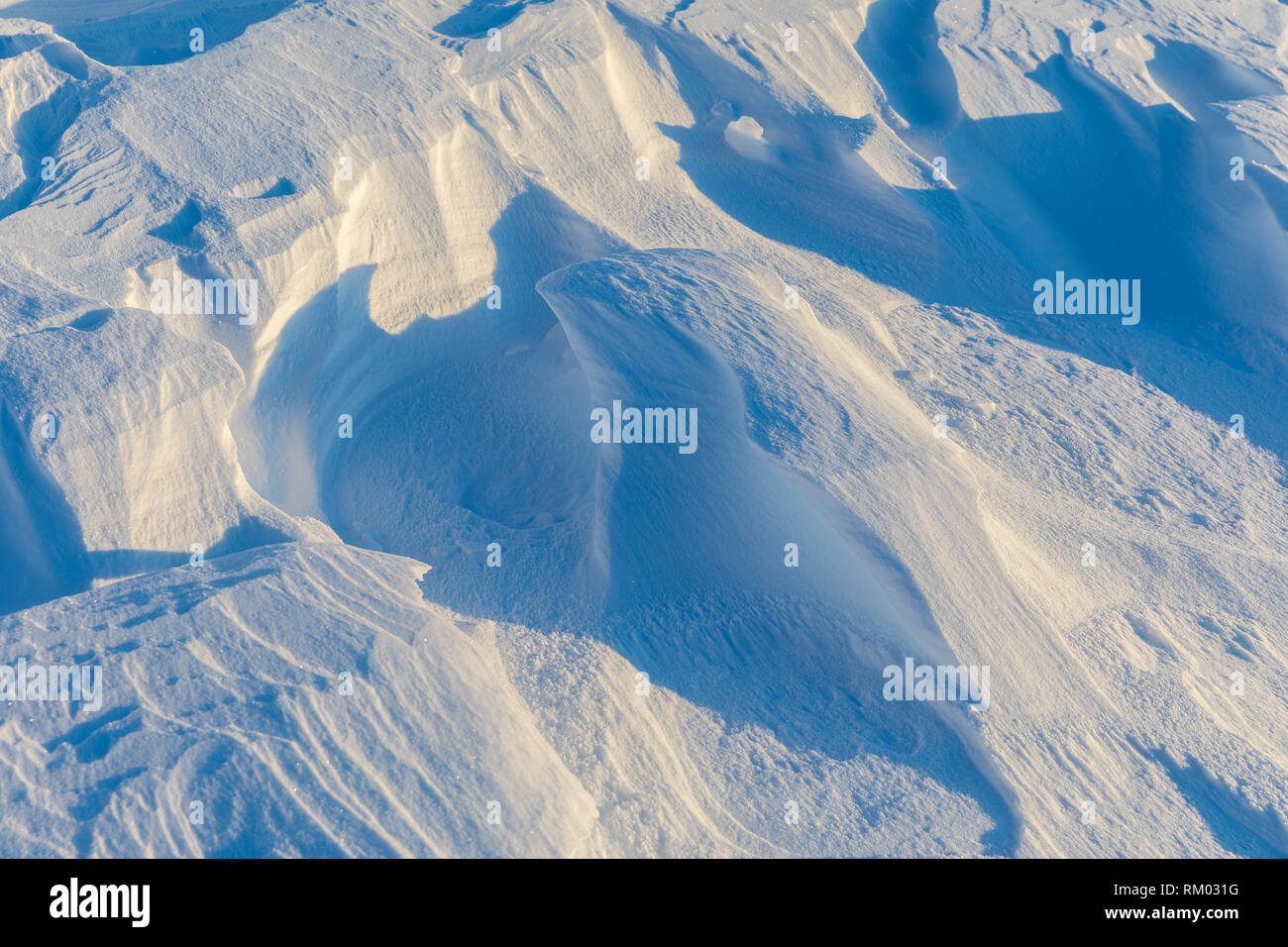 Sastrugi snow with shadows and sun Stock Photo - Alamy