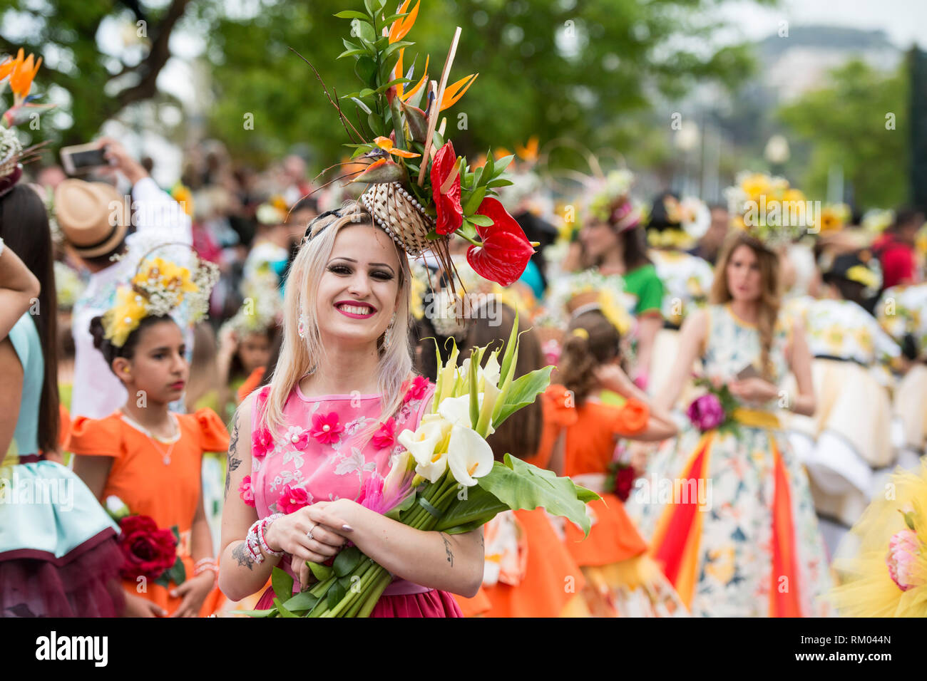 women dressed in colorful clothes at the Festa da Flor or Spring Flower ...