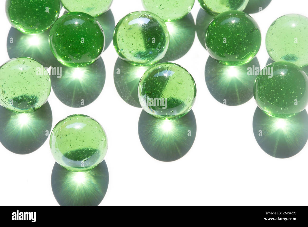 Green glass marbles with shadows Stock Photo - Alamy
