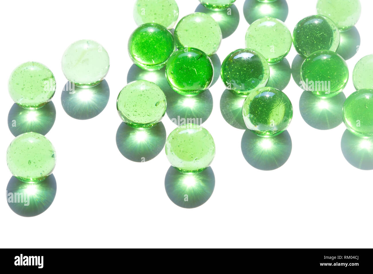 Green glass marbles with shadows Stock Photo - Alamy