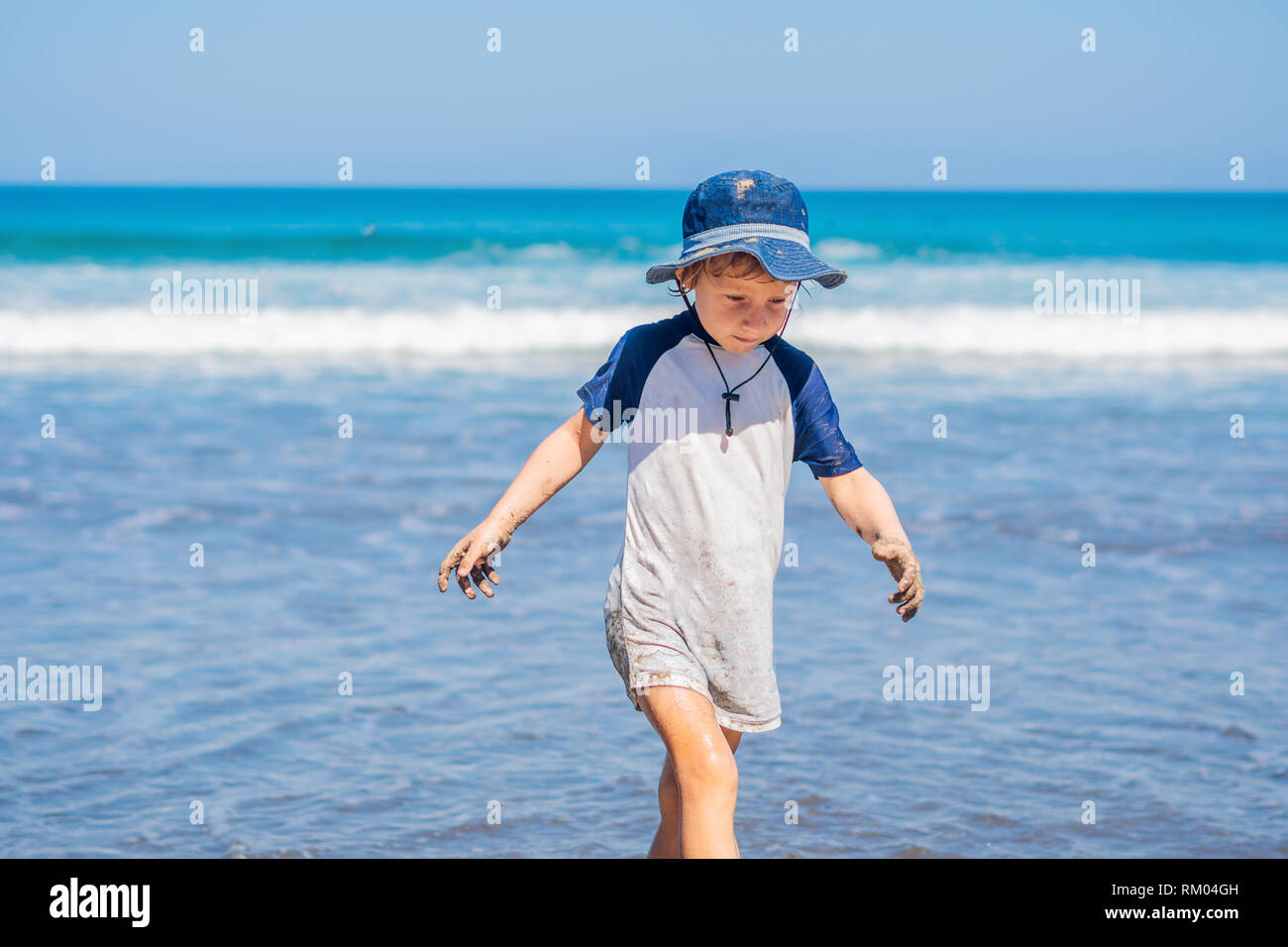 happy little boy swimming on tropical beach Stock Photo - Alamy