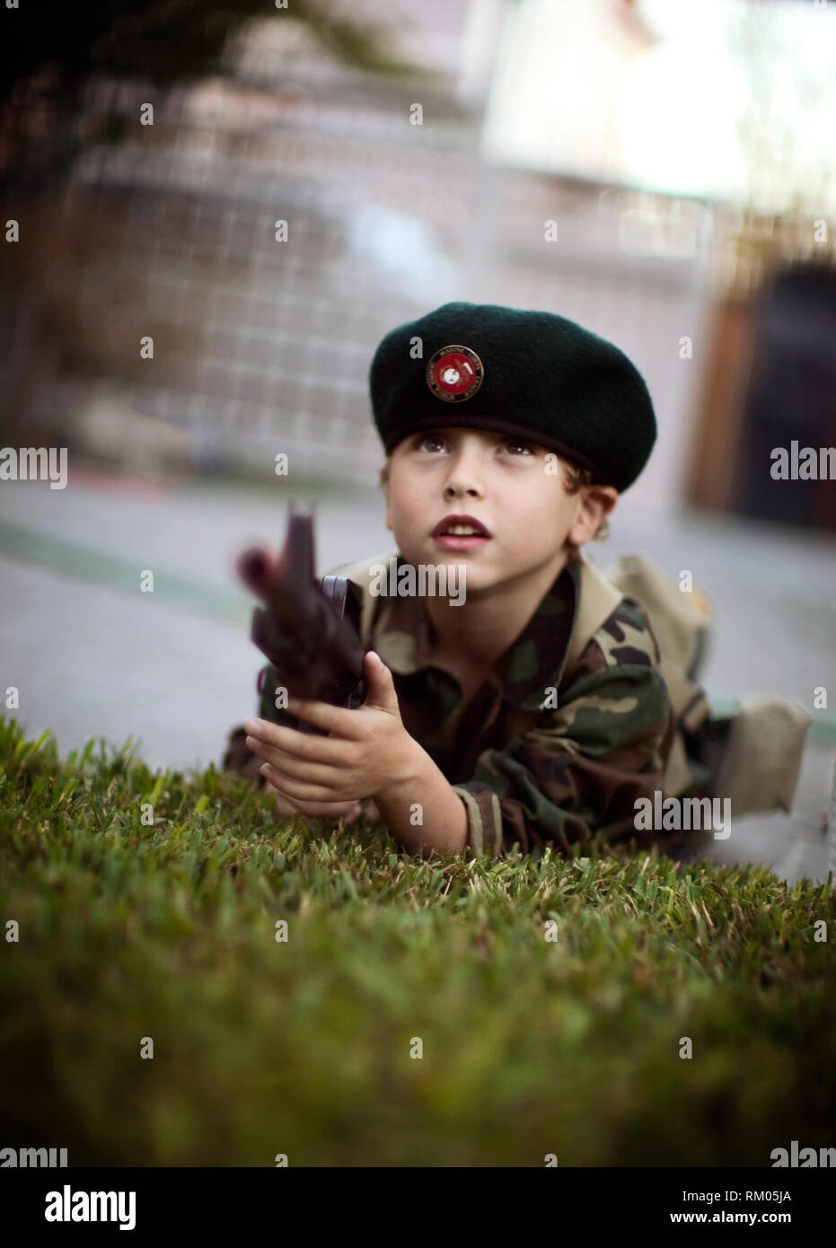 Young boy playing army Stock Photo - Alamy