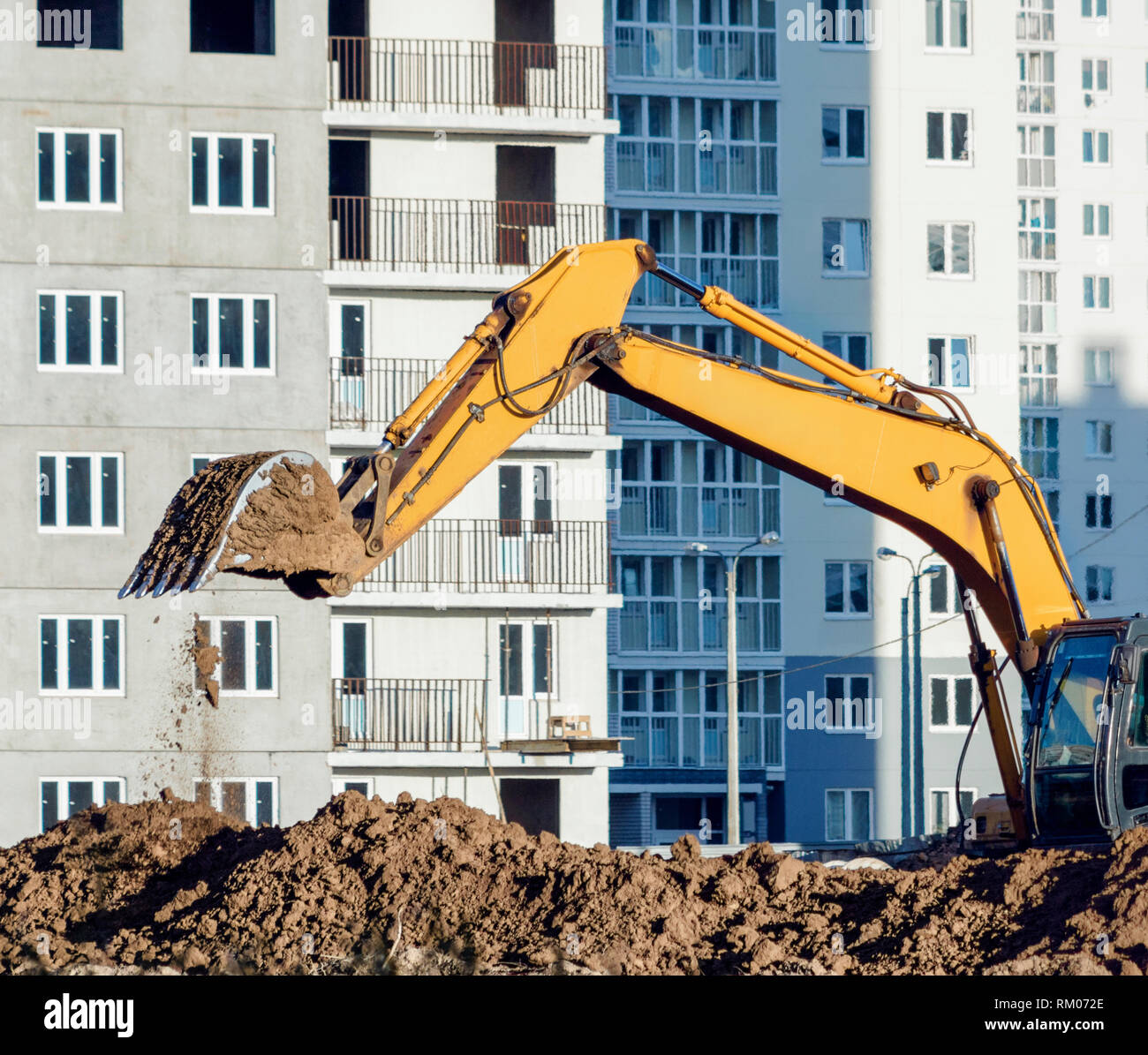 Yellow excavator digging the ground at the construction site Stock ...