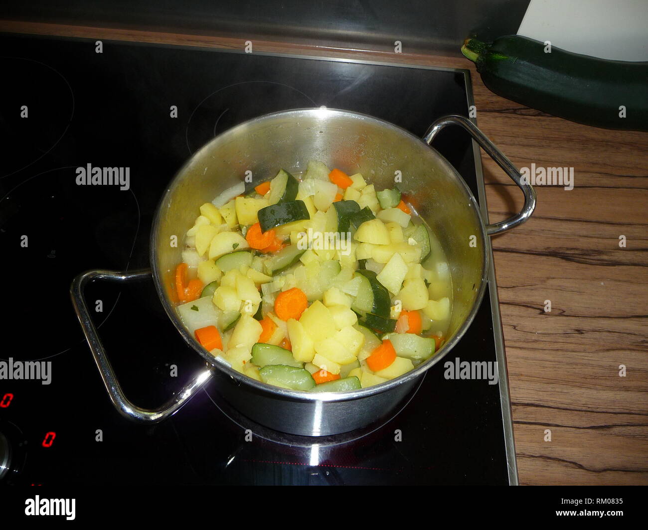Pot on the stove plate with vegetables which are boiled down Stock ...
