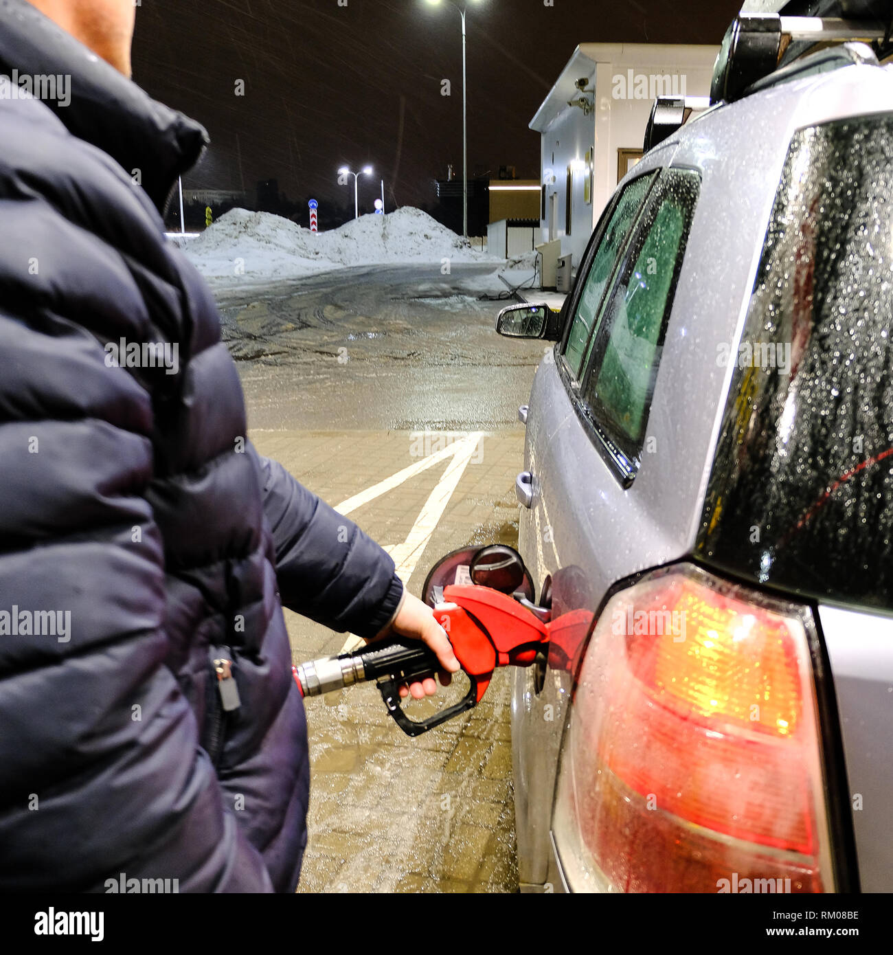 transportation and ownership concept - man pumping gasoline fuel in car at gas station Stock ...
