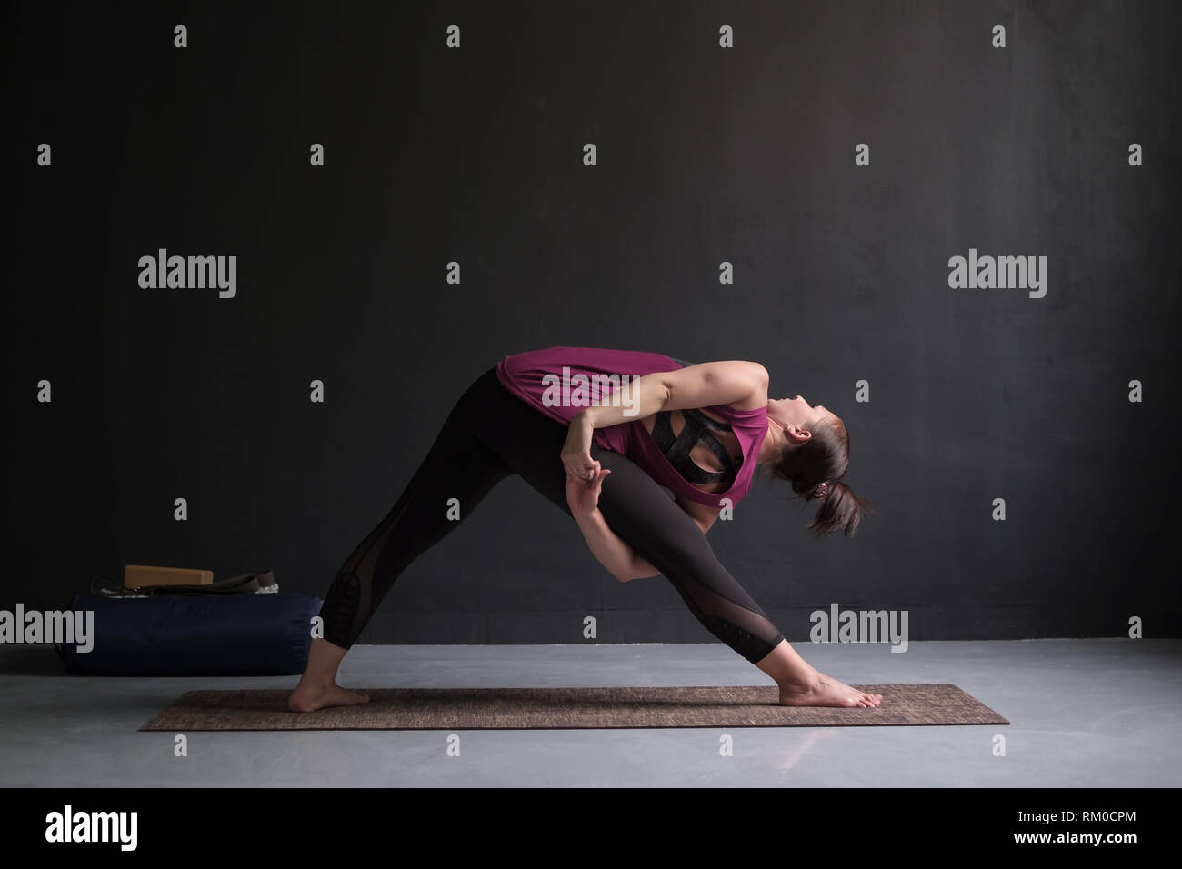 Girl standing in Utthita Trikonasana, extended triangle pose Stock ...