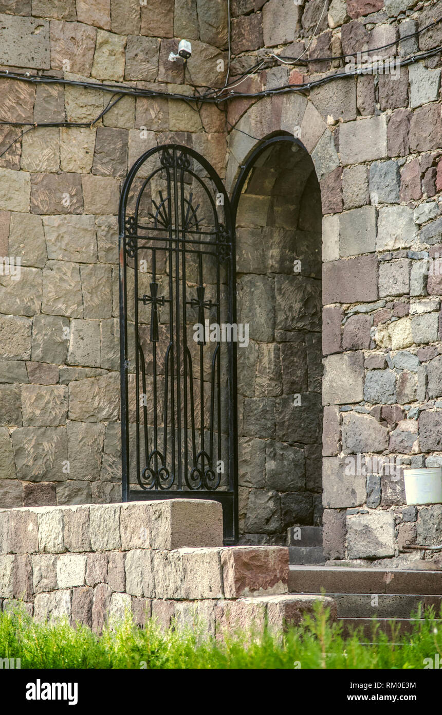 Stone staircase leading to arched doors with wrought-iron openwork door ...