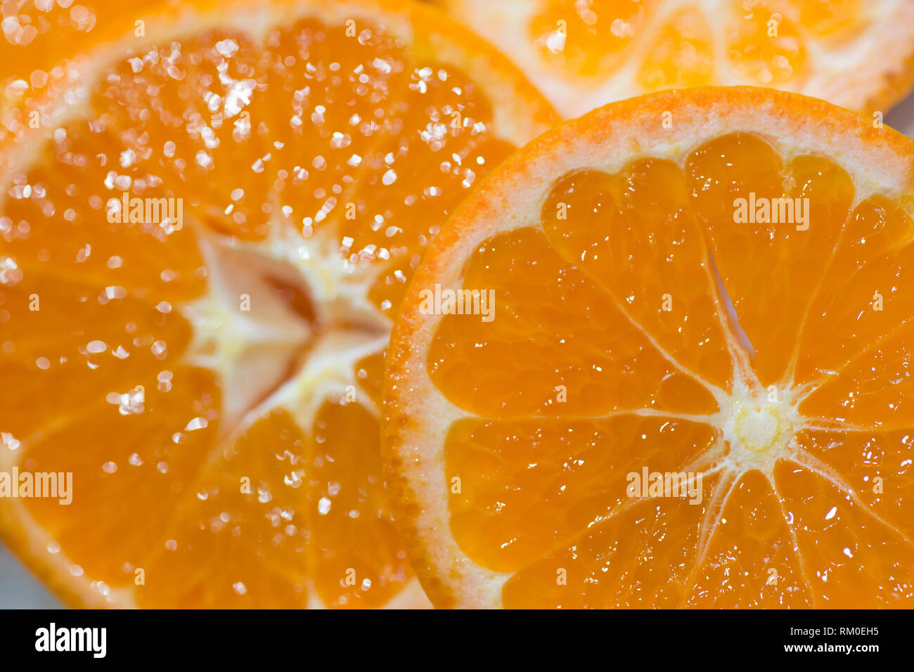 Freshly sliced oranges on a chopping board, showing the juicy fruit ...