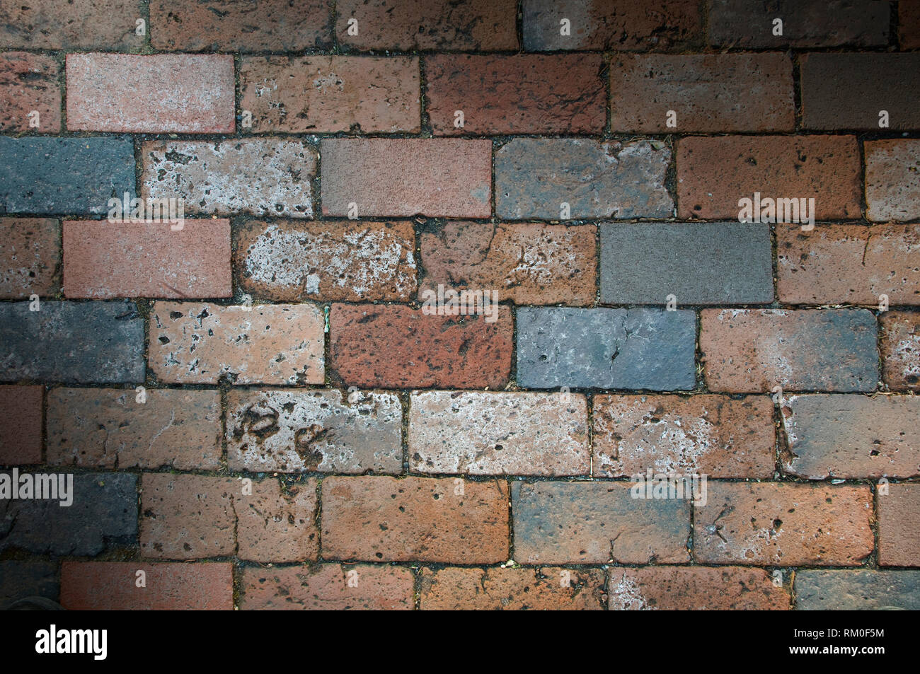 Multi-colored brick work texture lit diagonally Stock Photo - Alamy