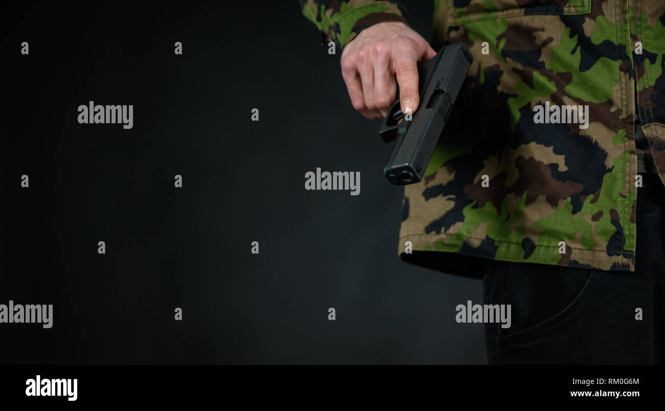 Soldier pulls his gun out Stock Photo - Alamy