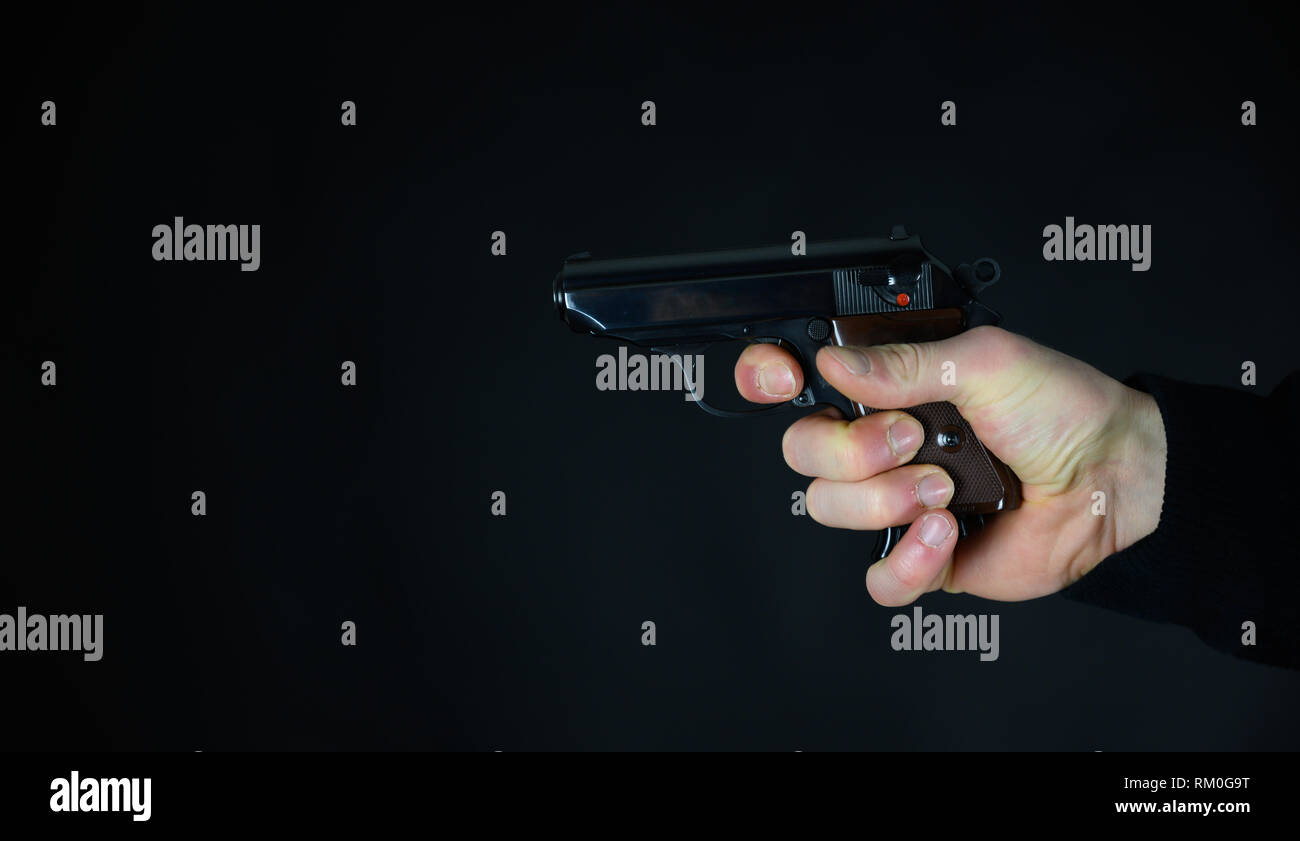 Man with a pistol in the hand Stock Photo - Alamy