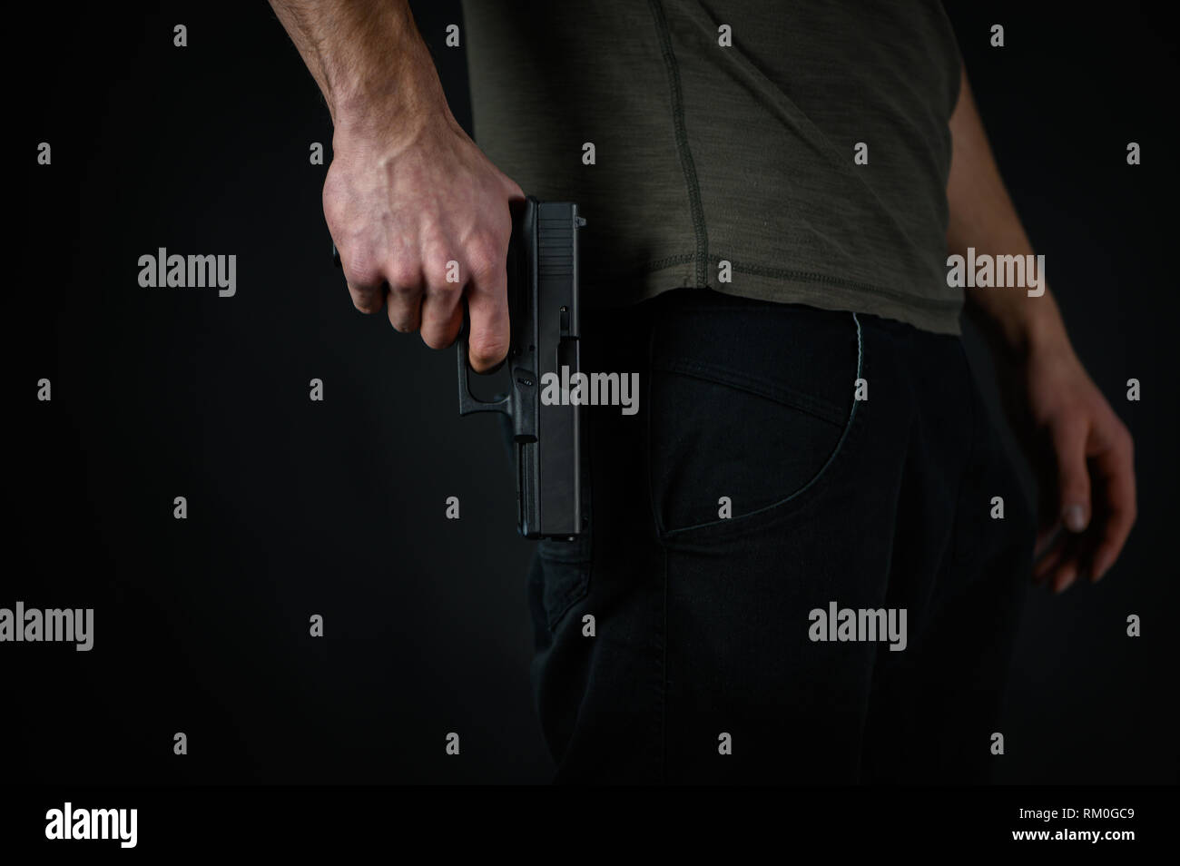 Man with a gun in the hand Stock Photo - Alamy