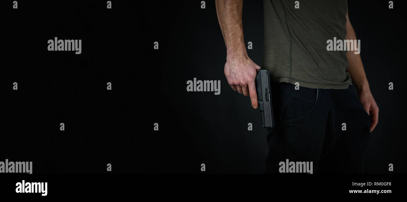 Man with a pistol in the hand Stock Photo - Alamy