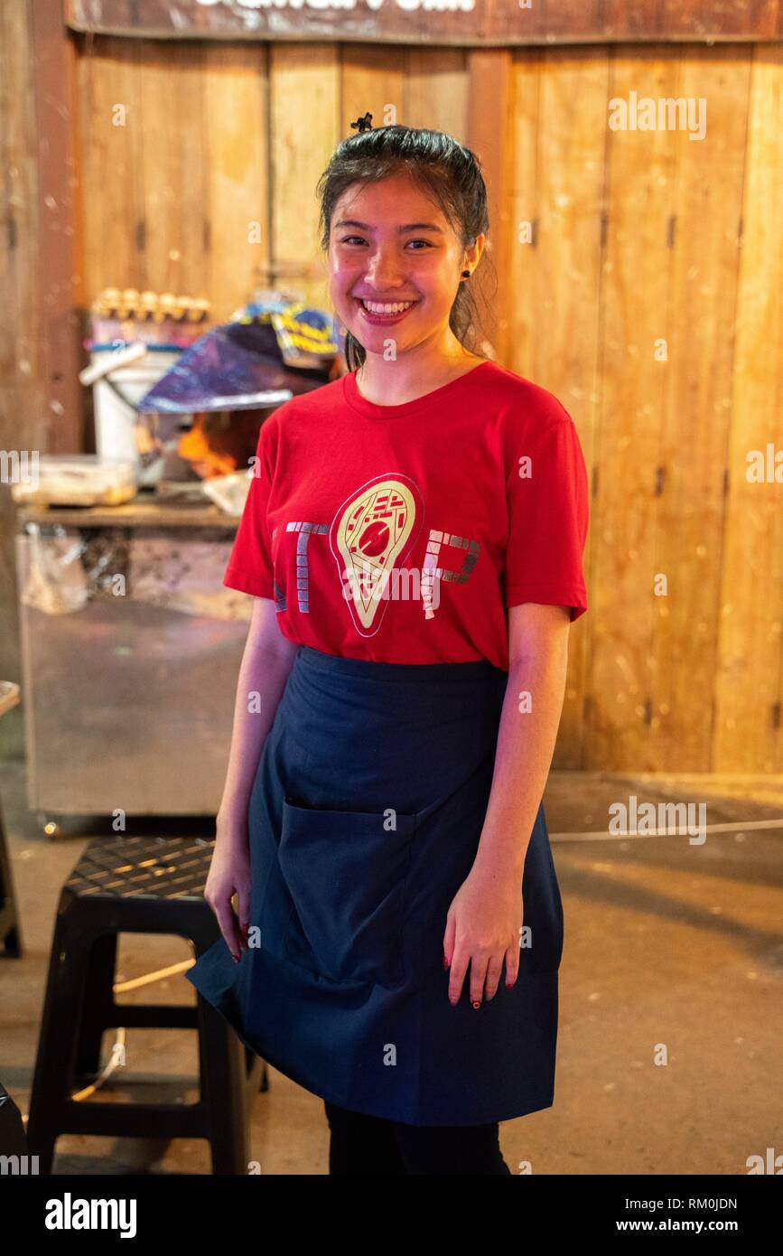 A happy waitress at Cowboy night in Siniawan oldtown, Sarawak, Malaysia ...